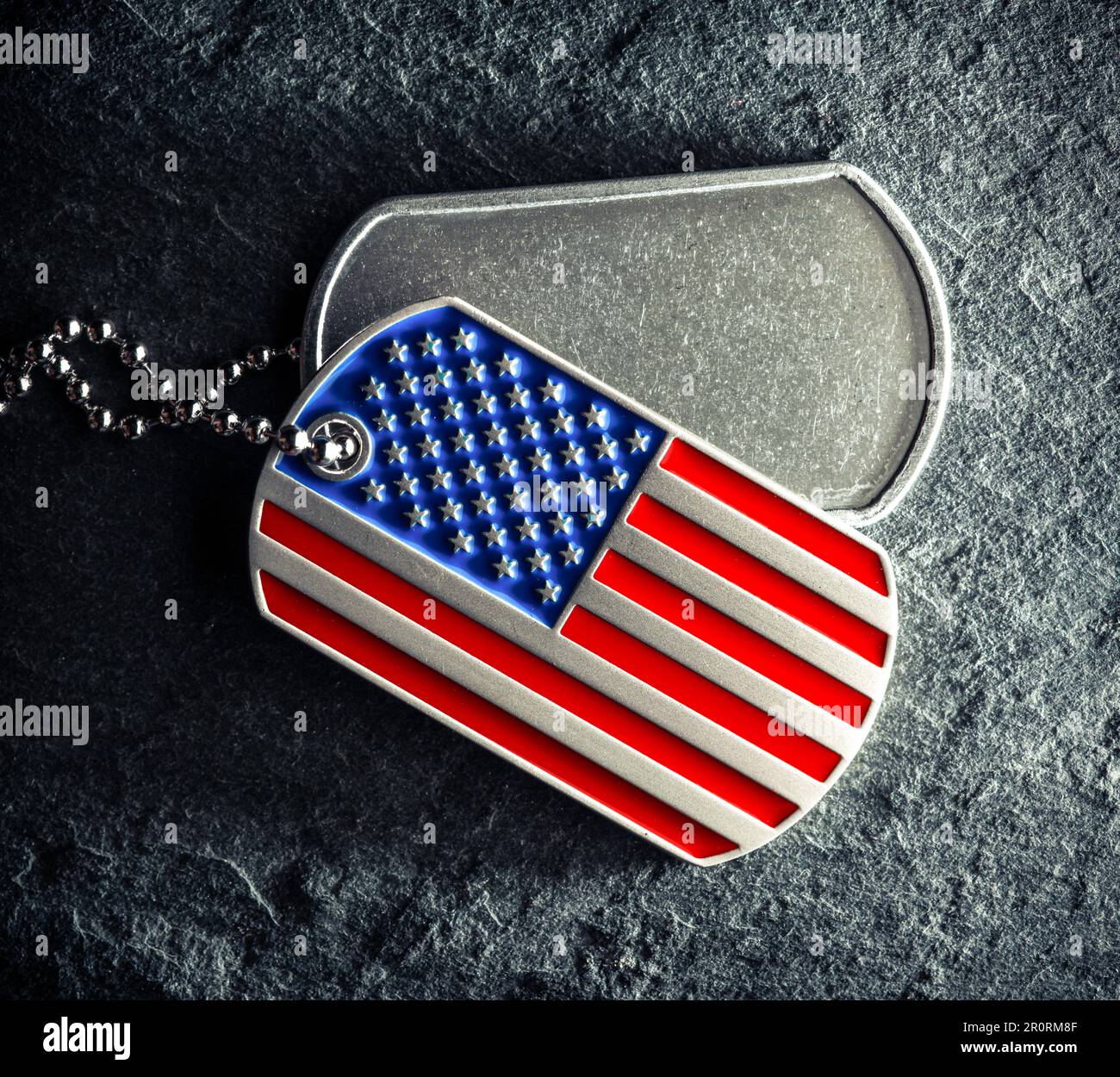 US military soldier's dog tags, rough and worn with blank space for ...