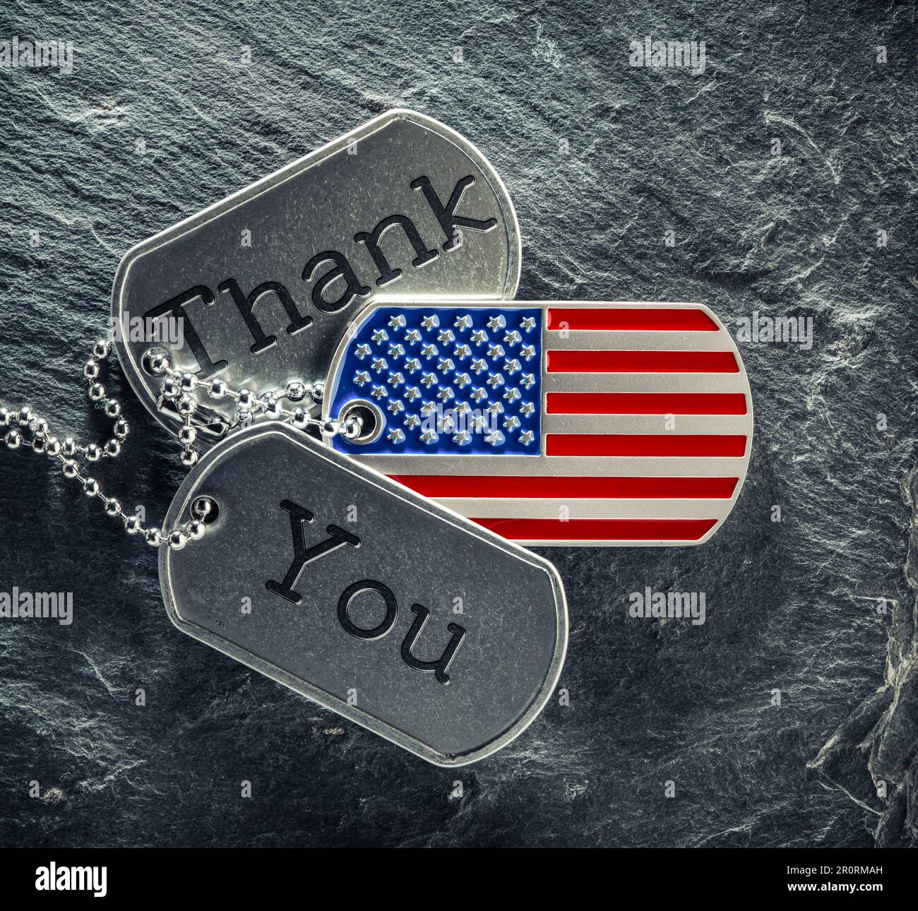 US military soldier's dog tags engraved with Thank You text and in the ...