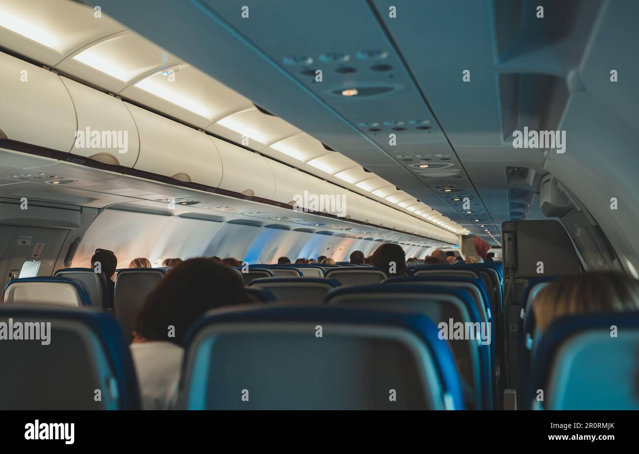 Interior inside of the plane with passengers Stock Photo - Alamy