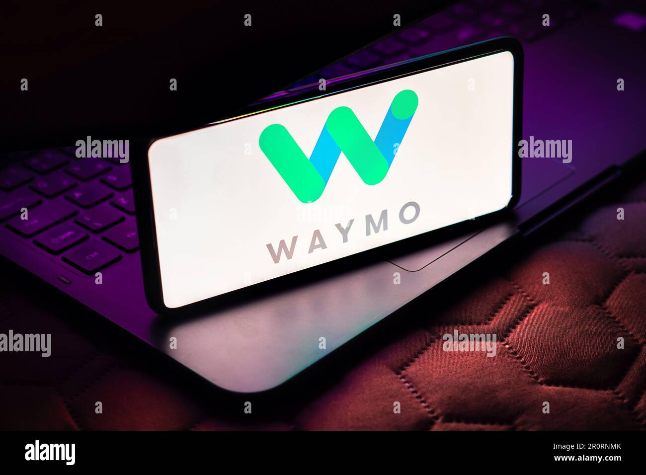 In this photo illustration, the Waymo logo is displayed on a smartphone ...
