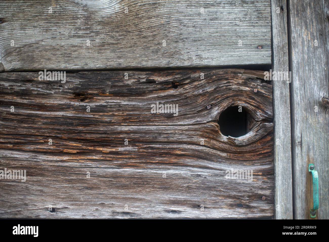 A knothole on the wall of an old barn Stock Photo - Alamy