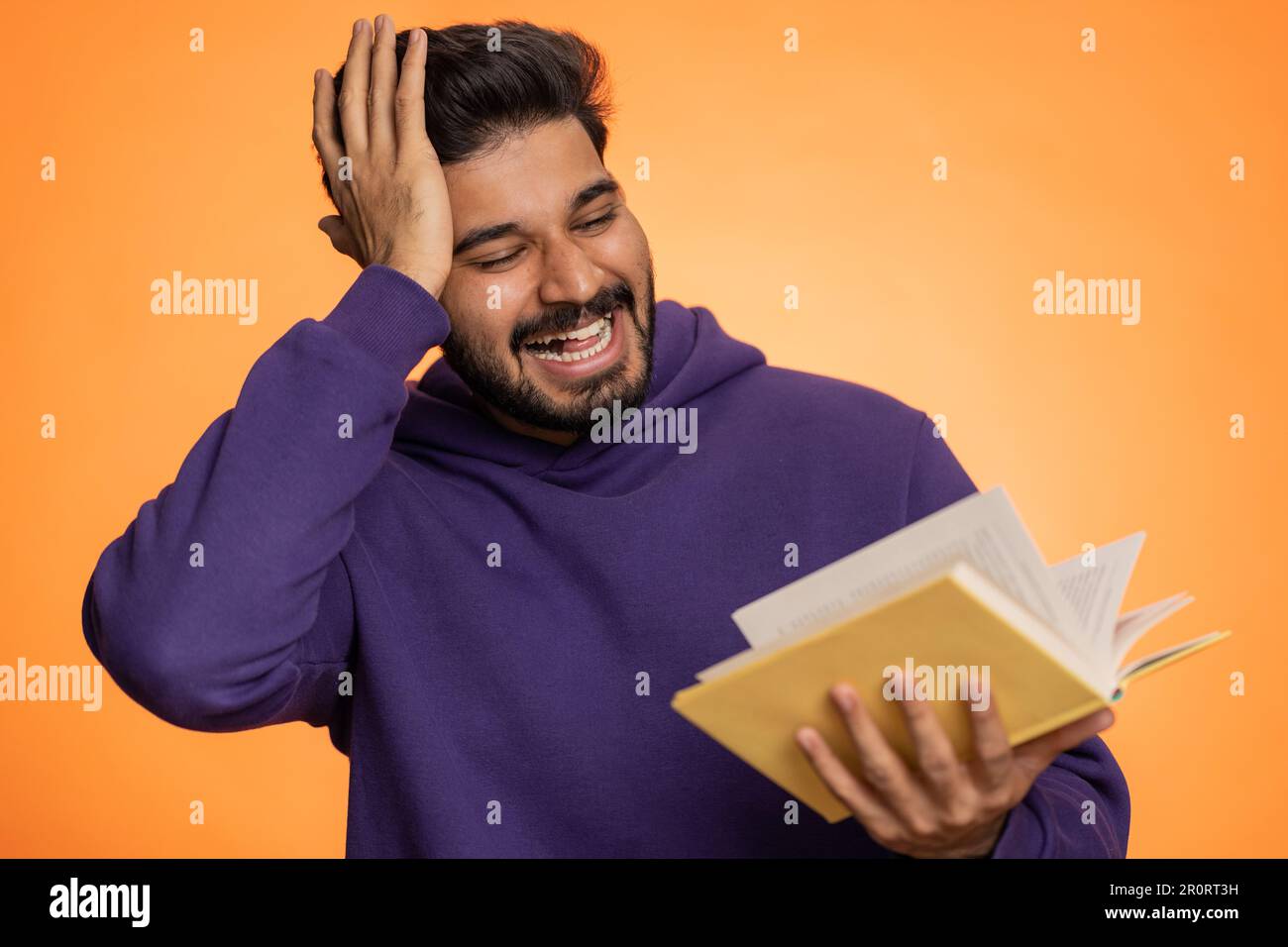 Happy indian man reading funny interesting fairytale story book ...