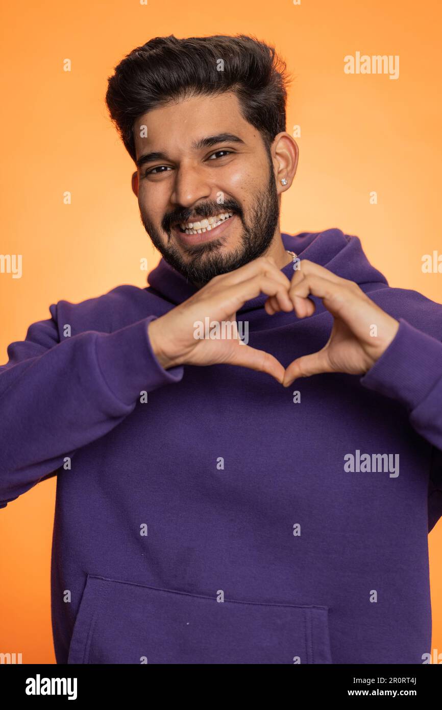 Man in love. Smiling bearded indian man 25 years old makes heart ...