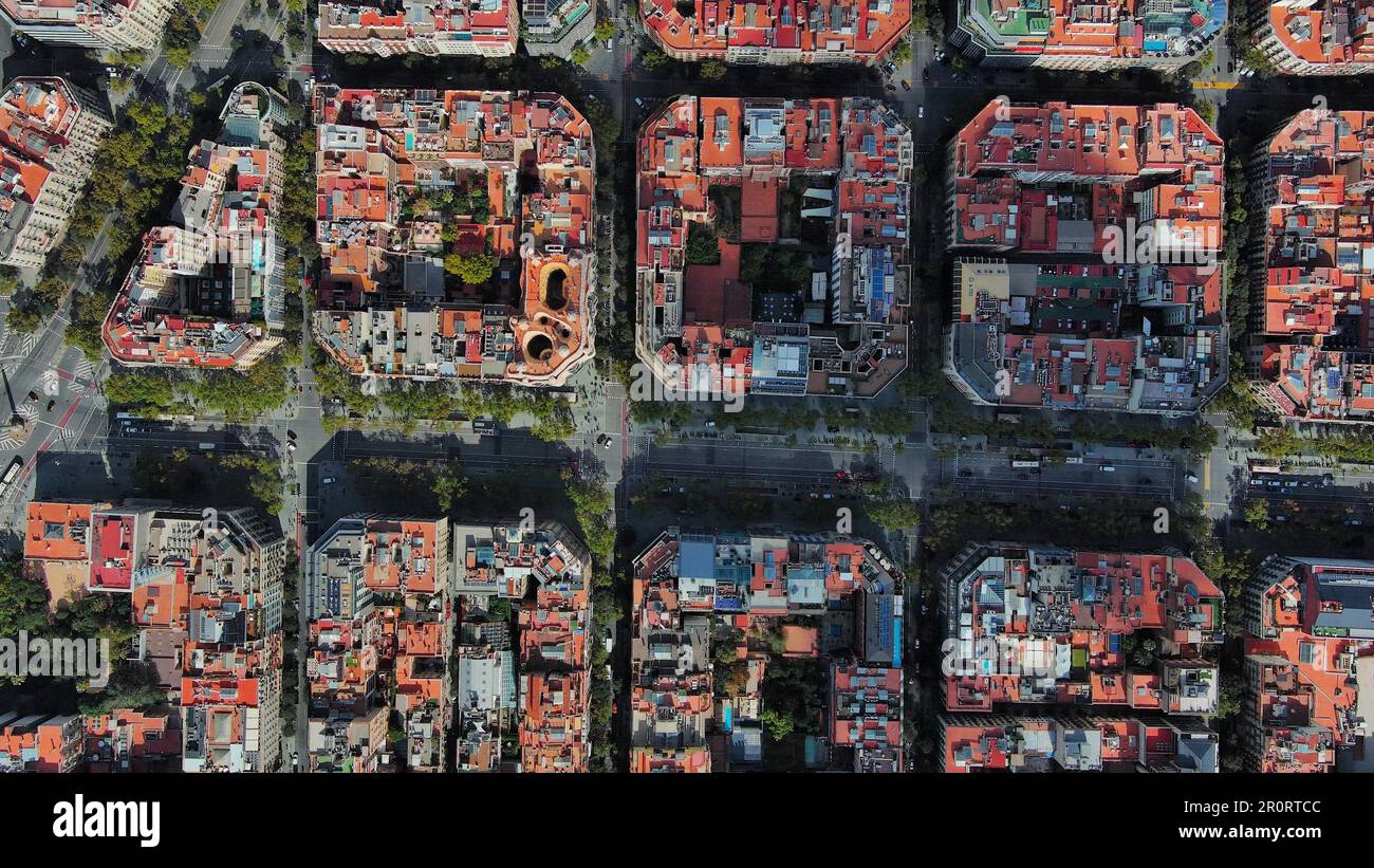 Aerial Birds Eye view of square buildings and traffic moving through ...