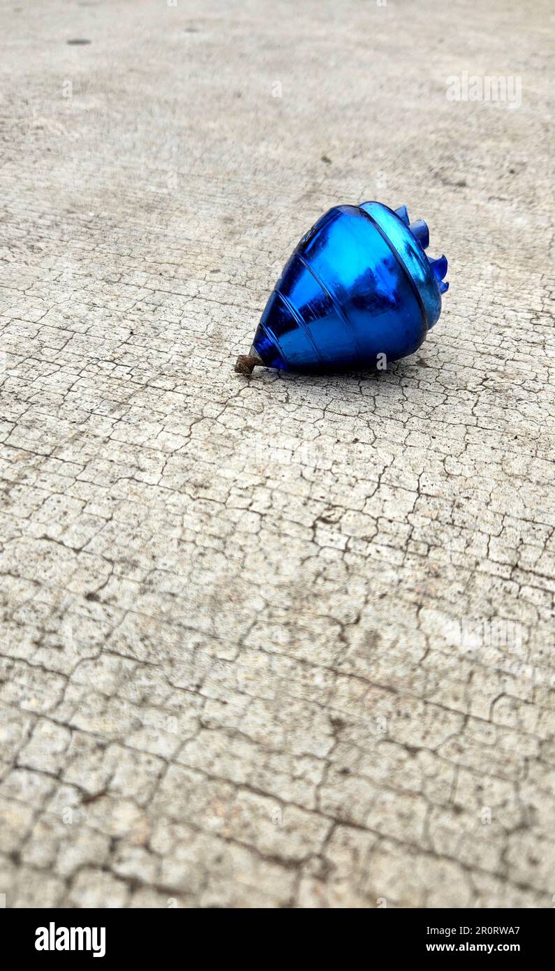 Blue spinning top, toy for children and adults, a type of spinning top ...