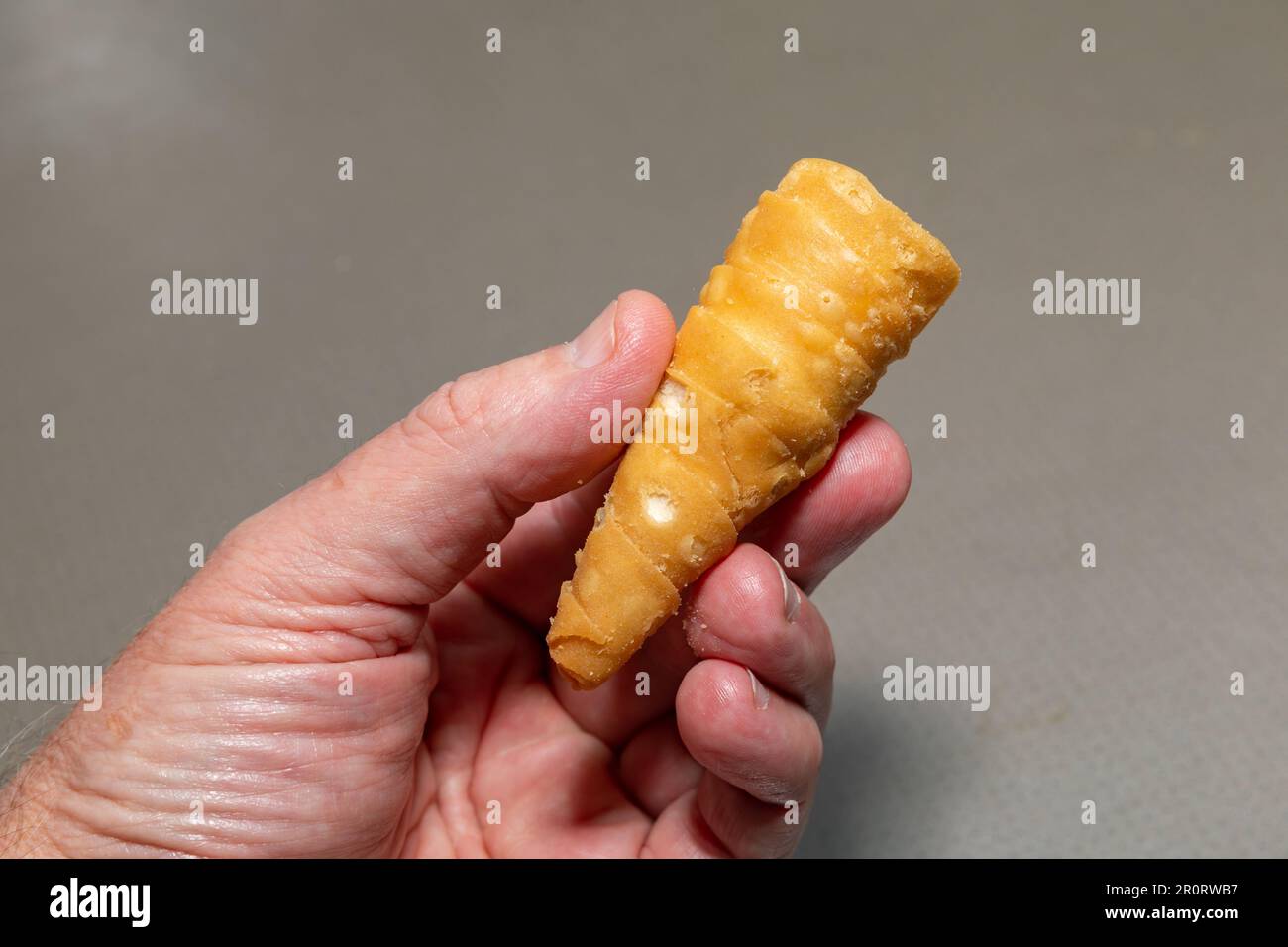 Traditional party snack known as "canudinho"or "tatu tail". Stuffed ...