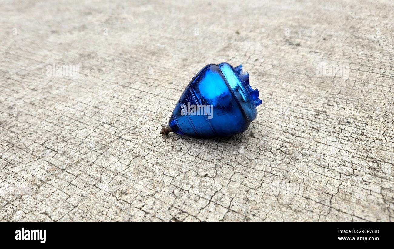 Blue spinning top, toy for children and adults, a type of spinning top ...