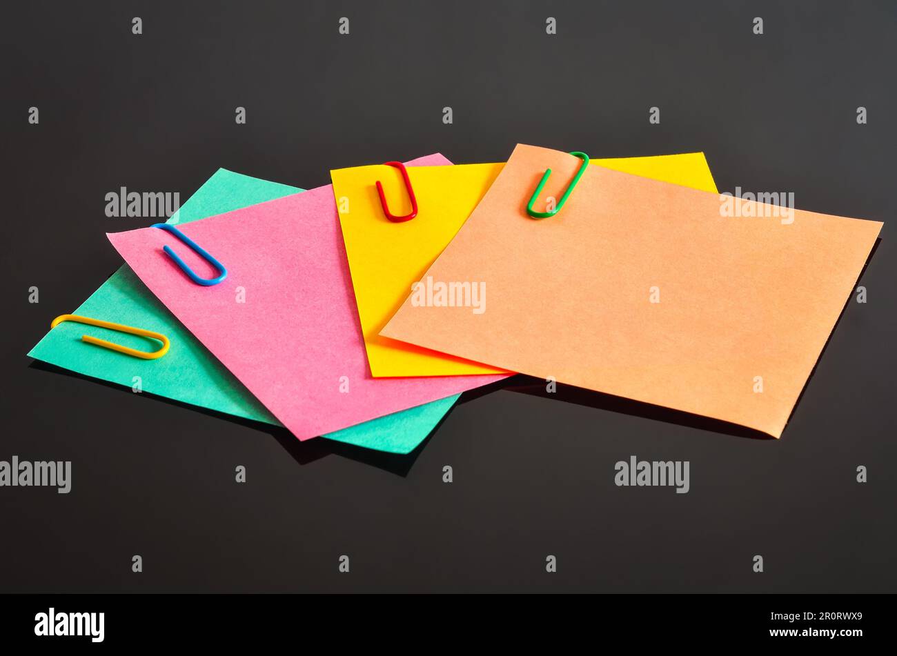 Colored sticky notes with paper clips. Concept for taking notes on ...