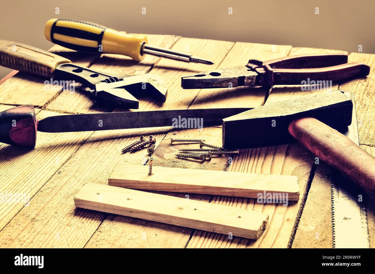 Renovation tools on the table. Hammer, flat file, pliers, screwdriver ...