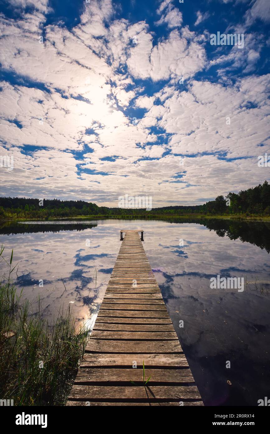 Beautiful summer afternoon landscape by the lake. Charming wooden pier ...
