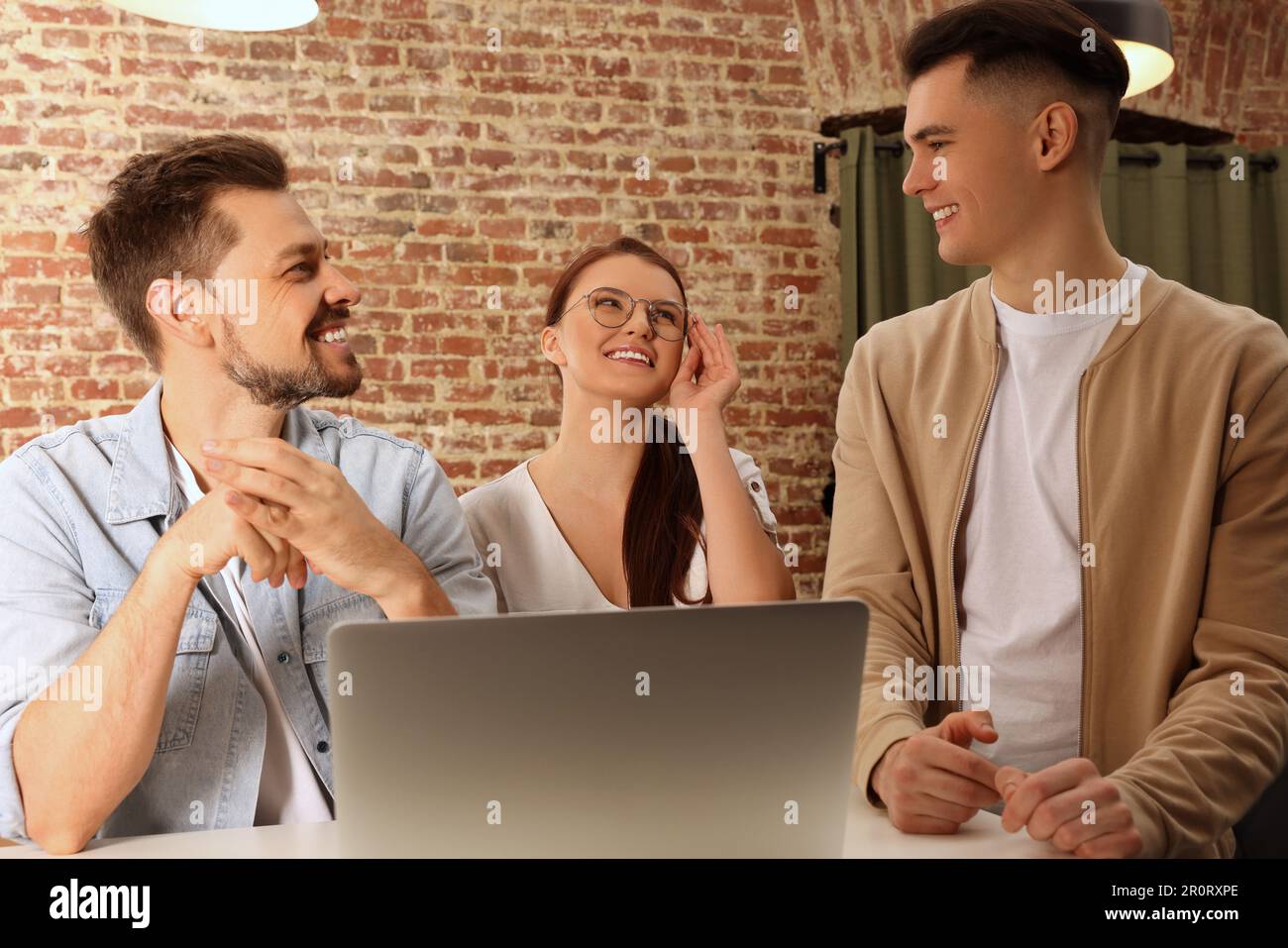 Team of employees working together in office Stock Photo - Alamy