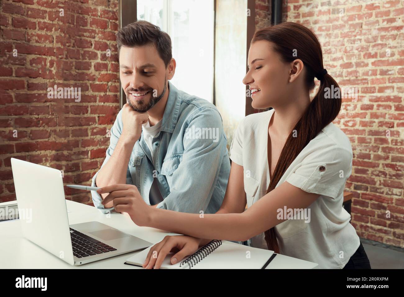 Team of employees working together in office Stock Photo - Alamy