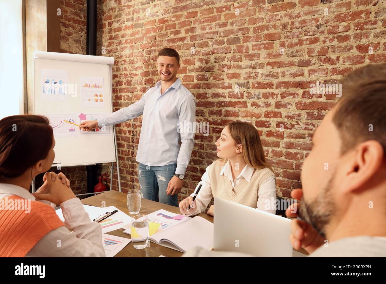 Employees having meeting in office. Team work Stock Photo - Alamy
