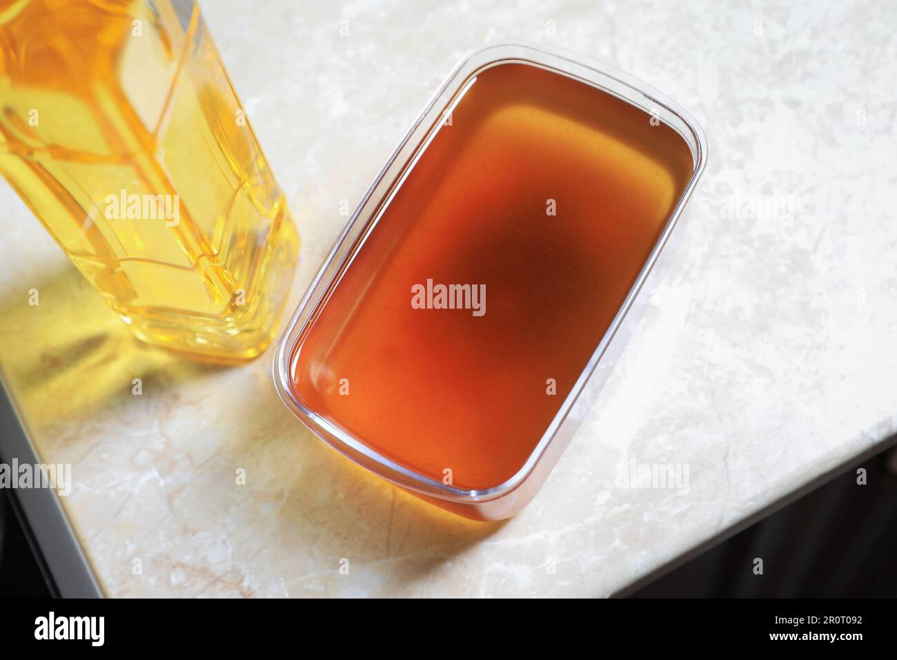 New and used cooking oil on beige marble table, above view Stock Photo ...