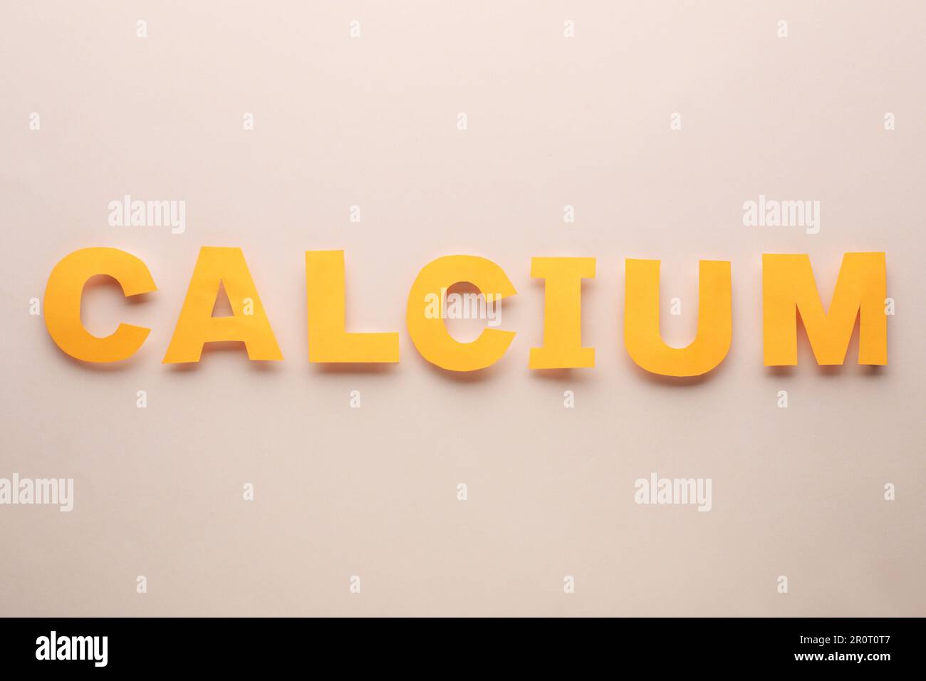 Word Calcium made of orange letters on beige background, flat lay Stock ...