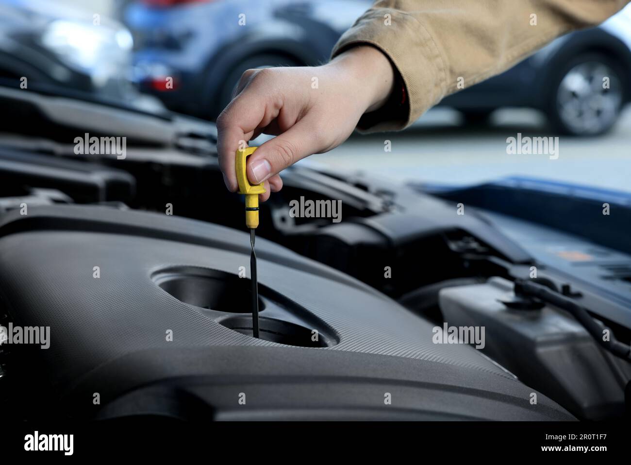 Man checking motor oil level in car with dipstick, closeup Stock Photo ...