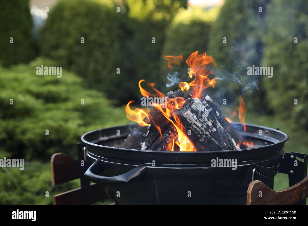 Portable barbecue grill with fire flames outdoors, closeup Stock Photo ...