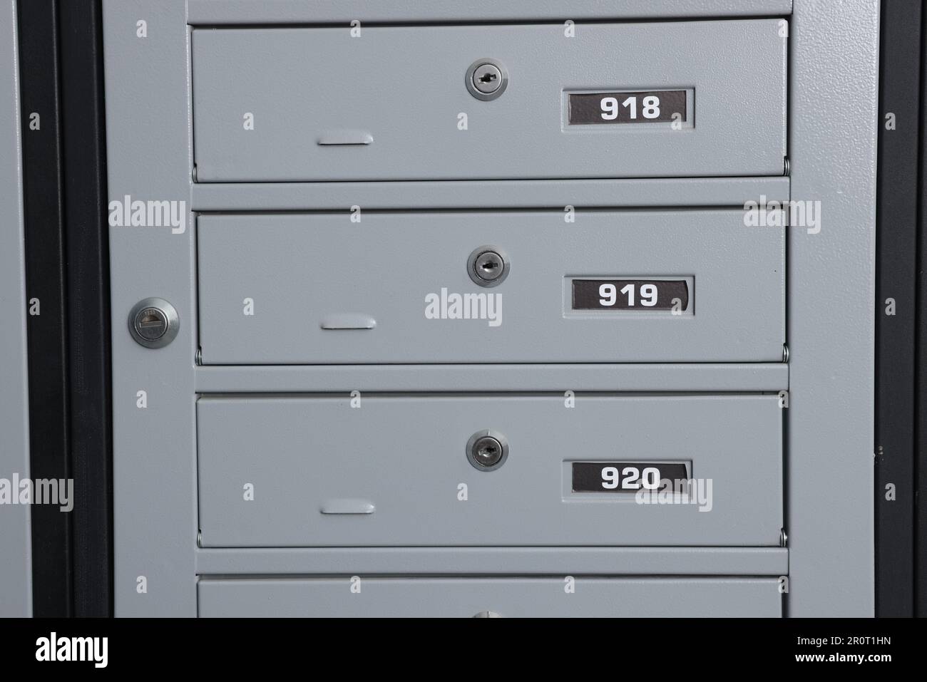 Closed metal mailboxes with keyholes and sequence numbers indoors Stock ...