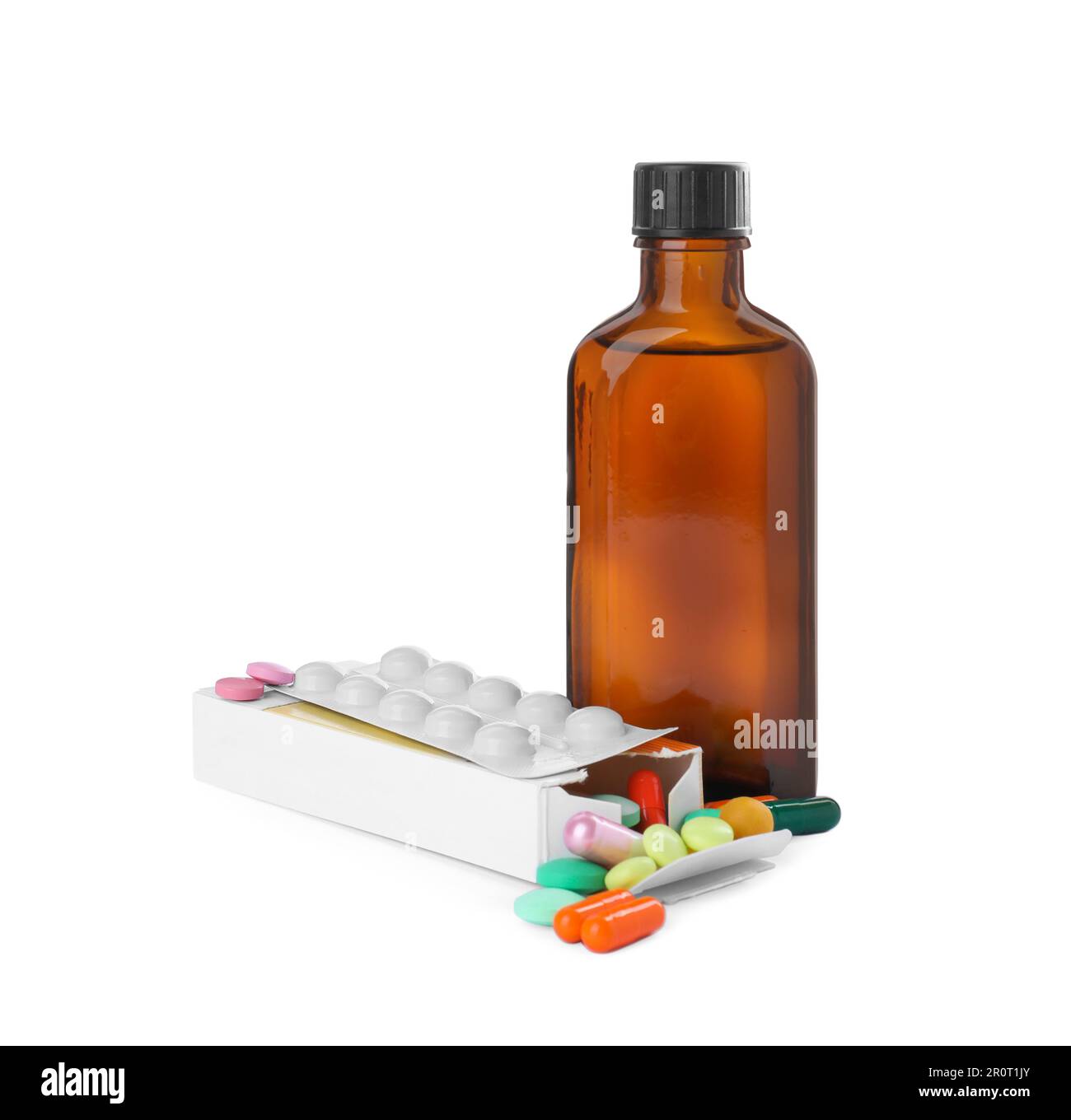 Bottle of syrup with pills on white background. Cough and cold medicine ...