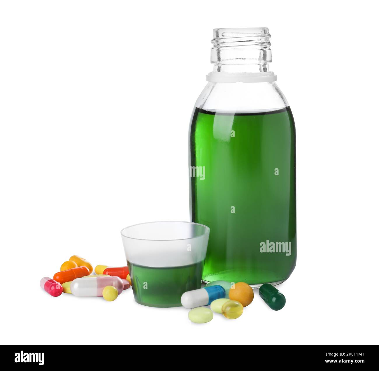 Pills, bottle with measuring cup of syrup on white background. Cough ...