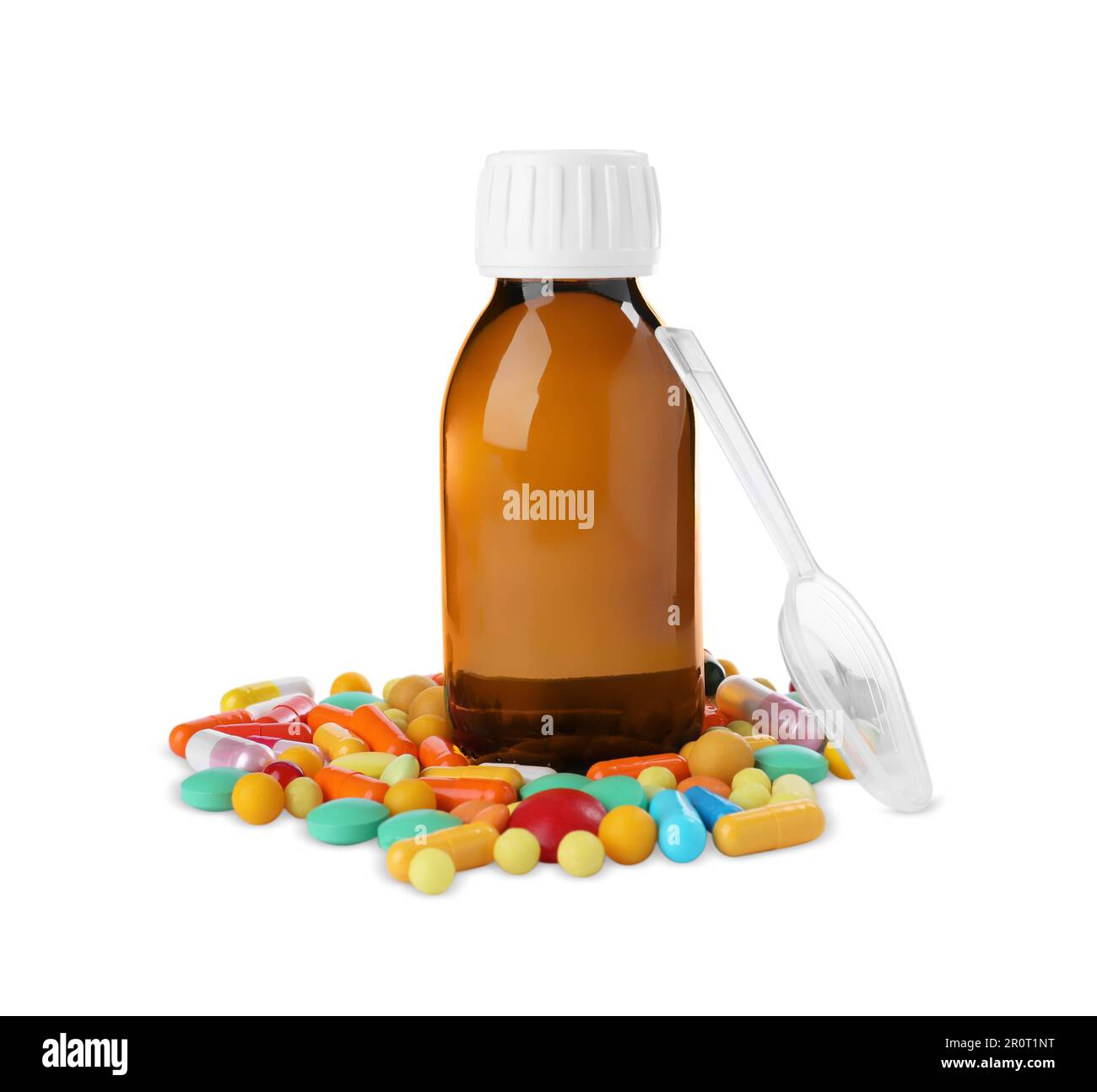 Bottle of syrup, plastic spoon with pills on white background. Cough ...