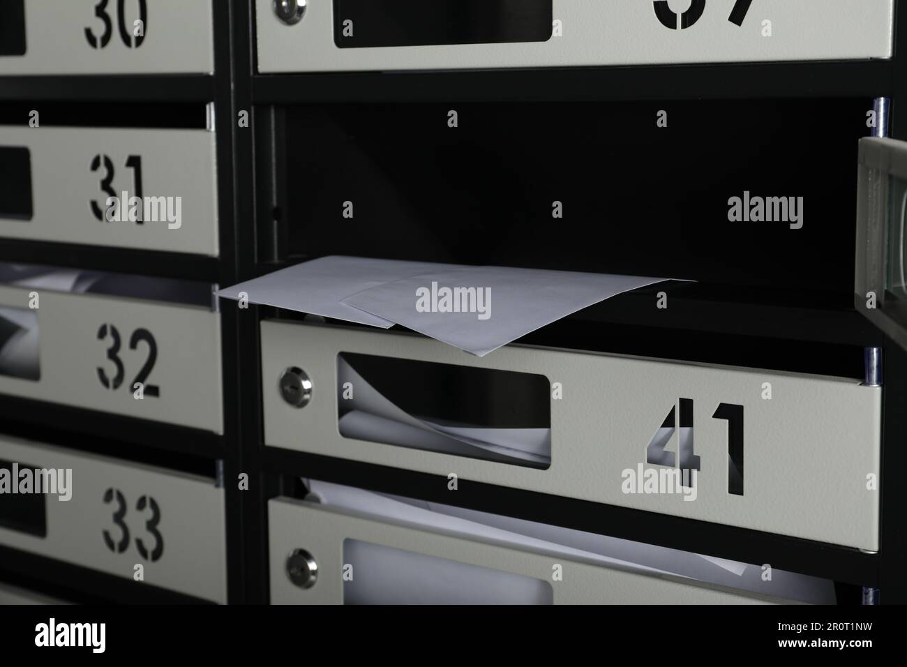 Open mailbox with keyhole, number and receipts, closeup Stock Photo - Alamy