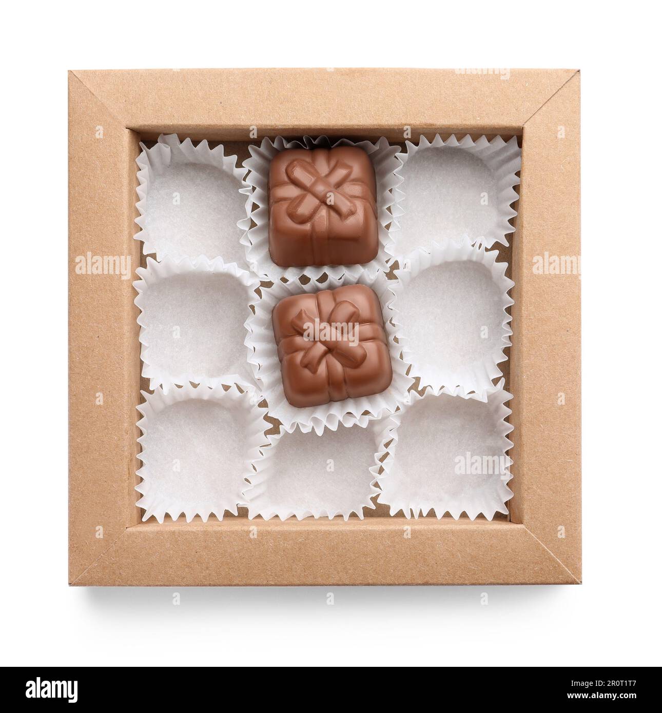 Partially empty box of chocolate candies isolated on white, top view ...
