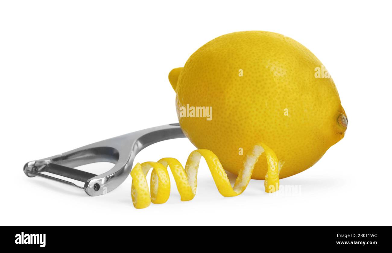 Peeler, fresh lemon and zest on white background Stock Photo - Alamy