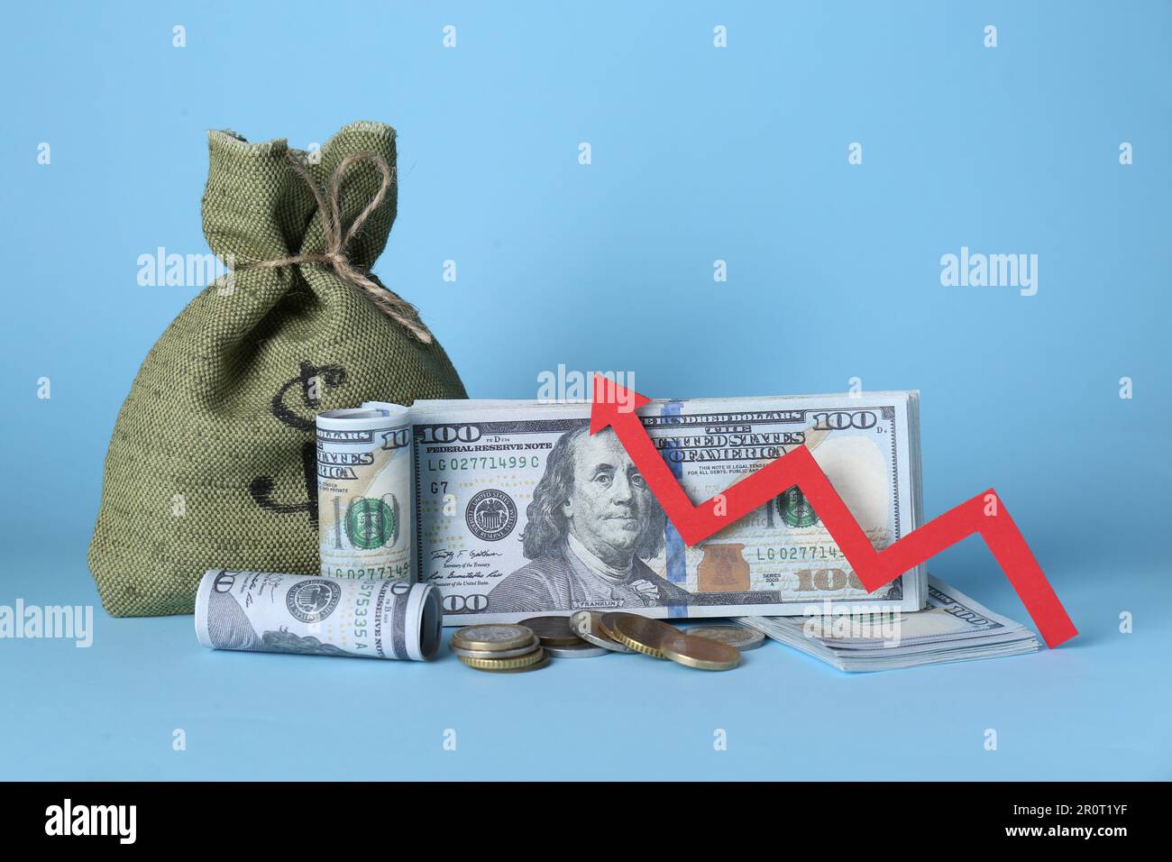 Economic profit. Money bag, coins, banknotes and arrow on light blue ...