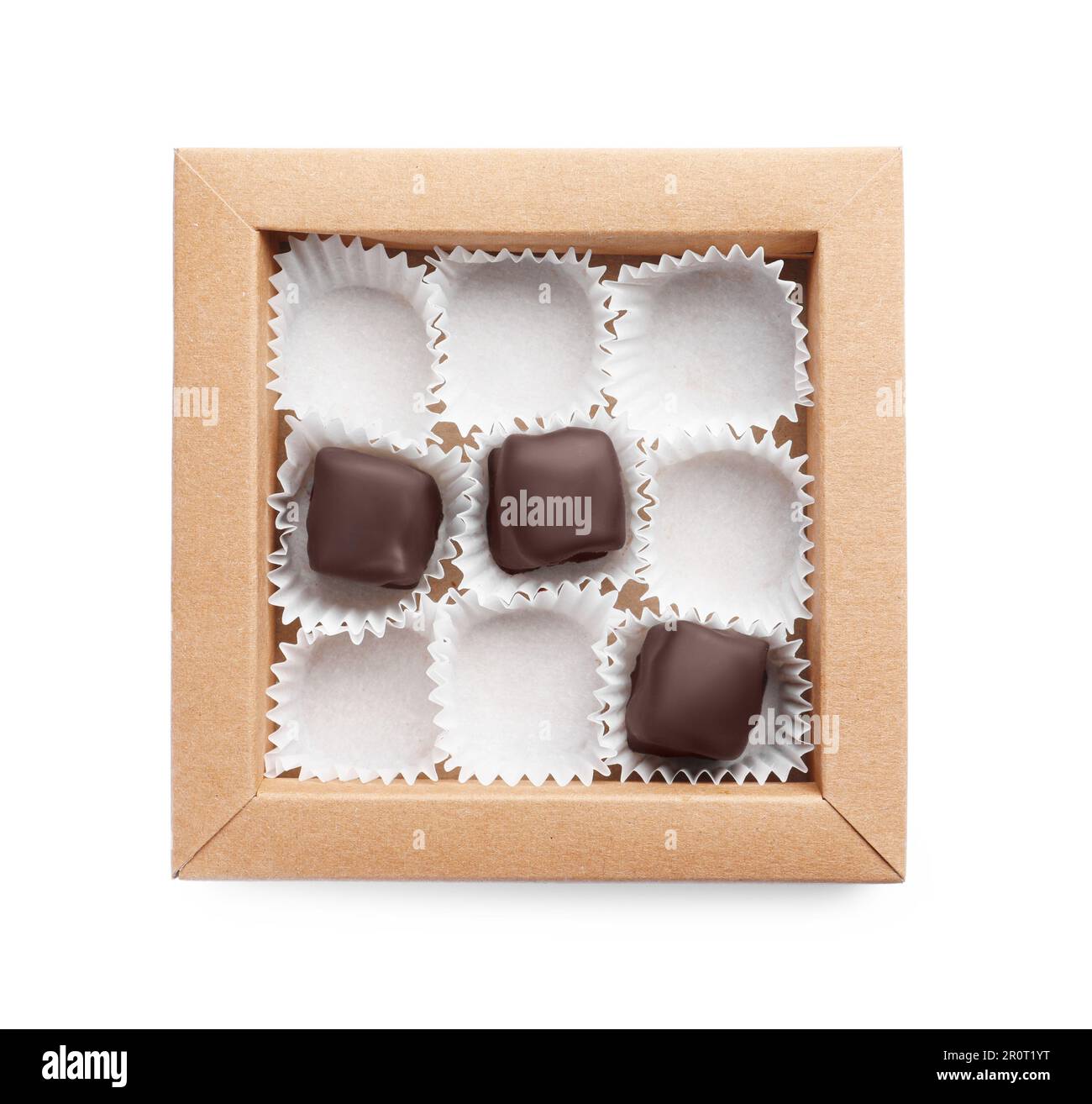 Partially empty box of chocolate candies isolated on white, top view ...