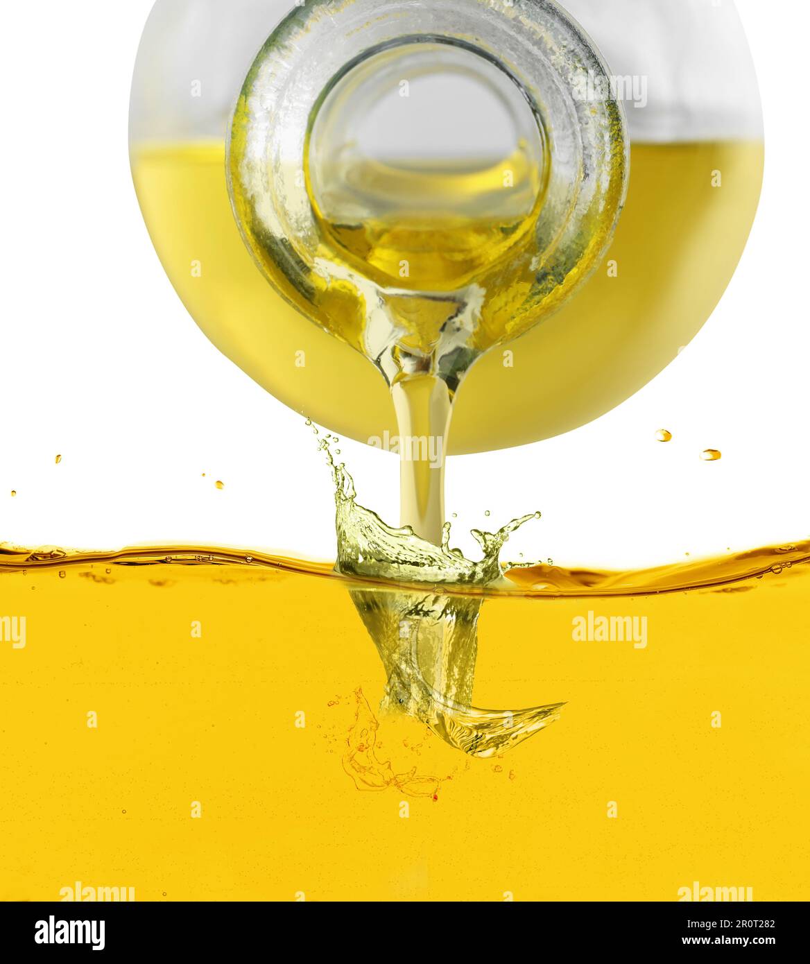 Pouring cooking oil from jug against white background Stock Photo - Alamy