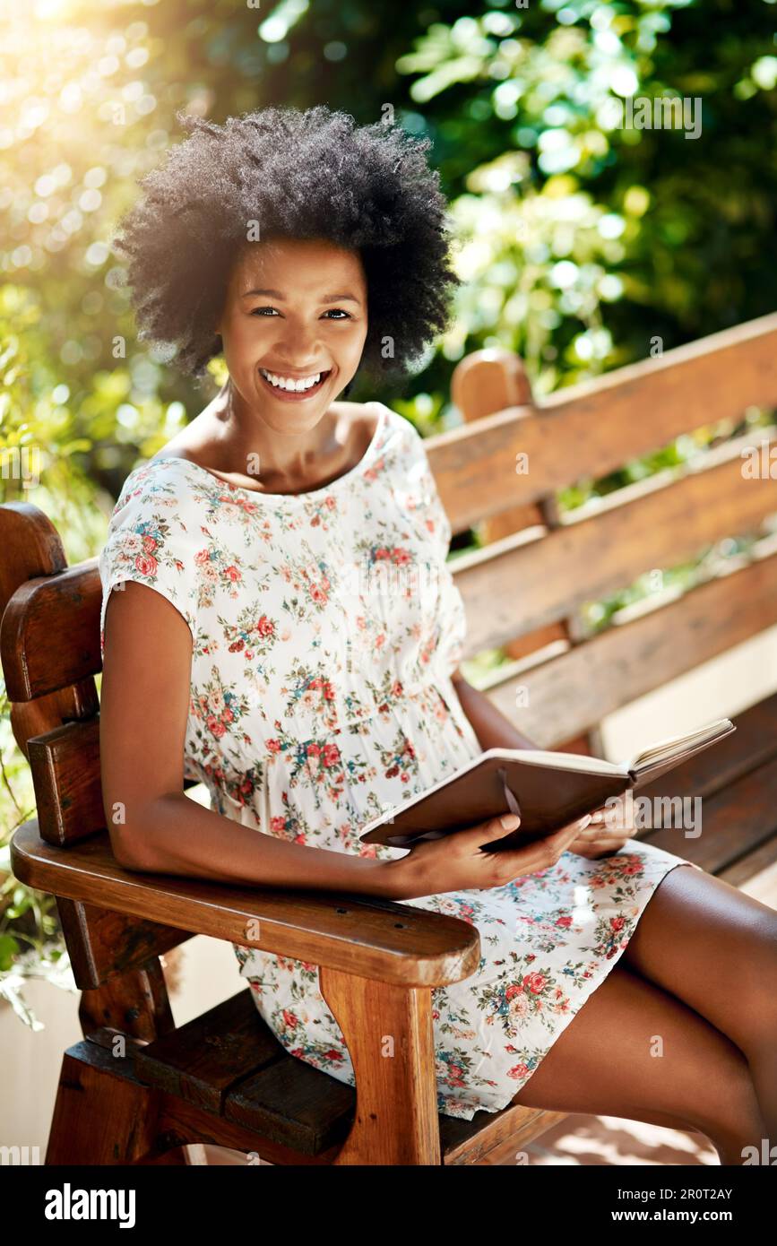 Its hard not to be happy when youre reading. Portrait of a young woman ...