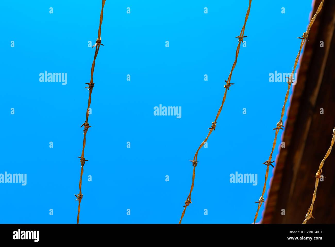 Barb wire for jail border . Barbed wire against sky Stock Photo - Alamy
