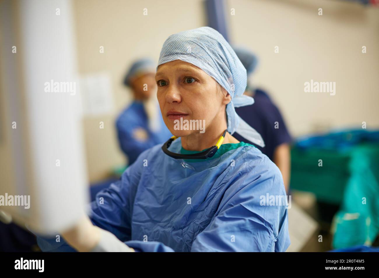 Keeping a close watch over her patients progress. a surgeon looking at ...