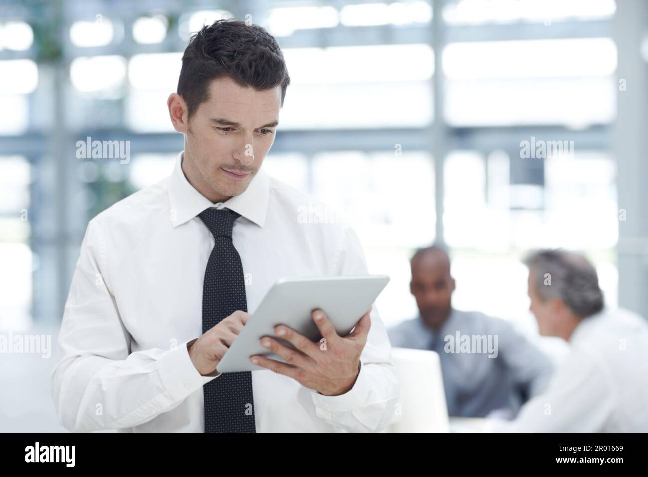 Making use of modern technology. A young businessman using his digital ...