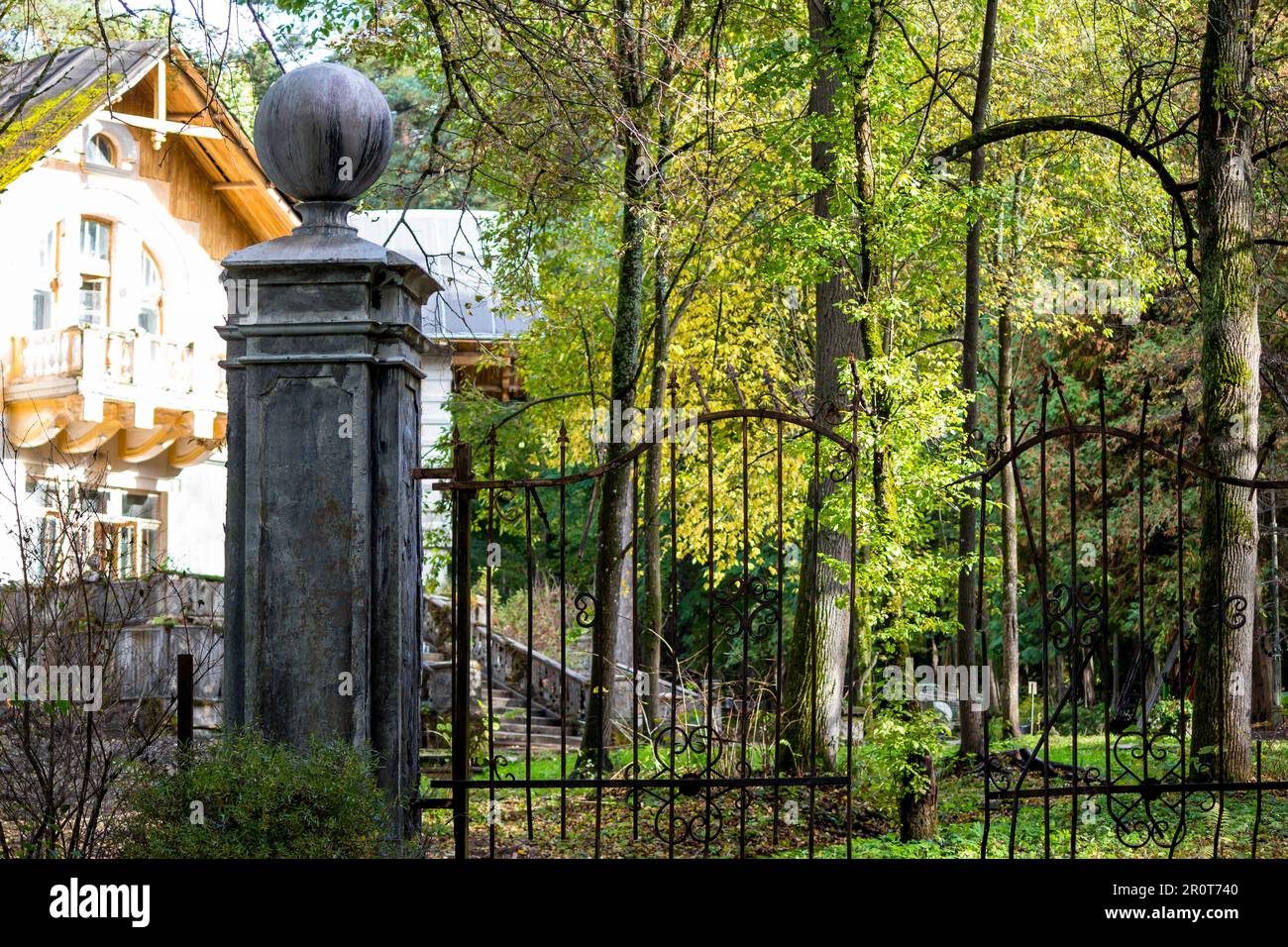 Decorative retro gate on the background of the facade of the old manor ...