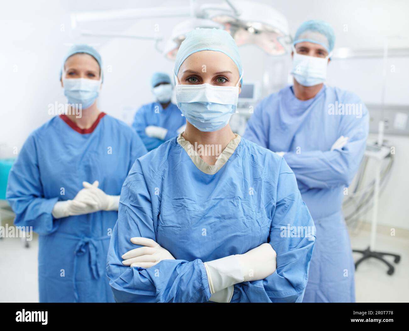 Trust us with your life. Group of surgeons wearing hospital scrubs ...