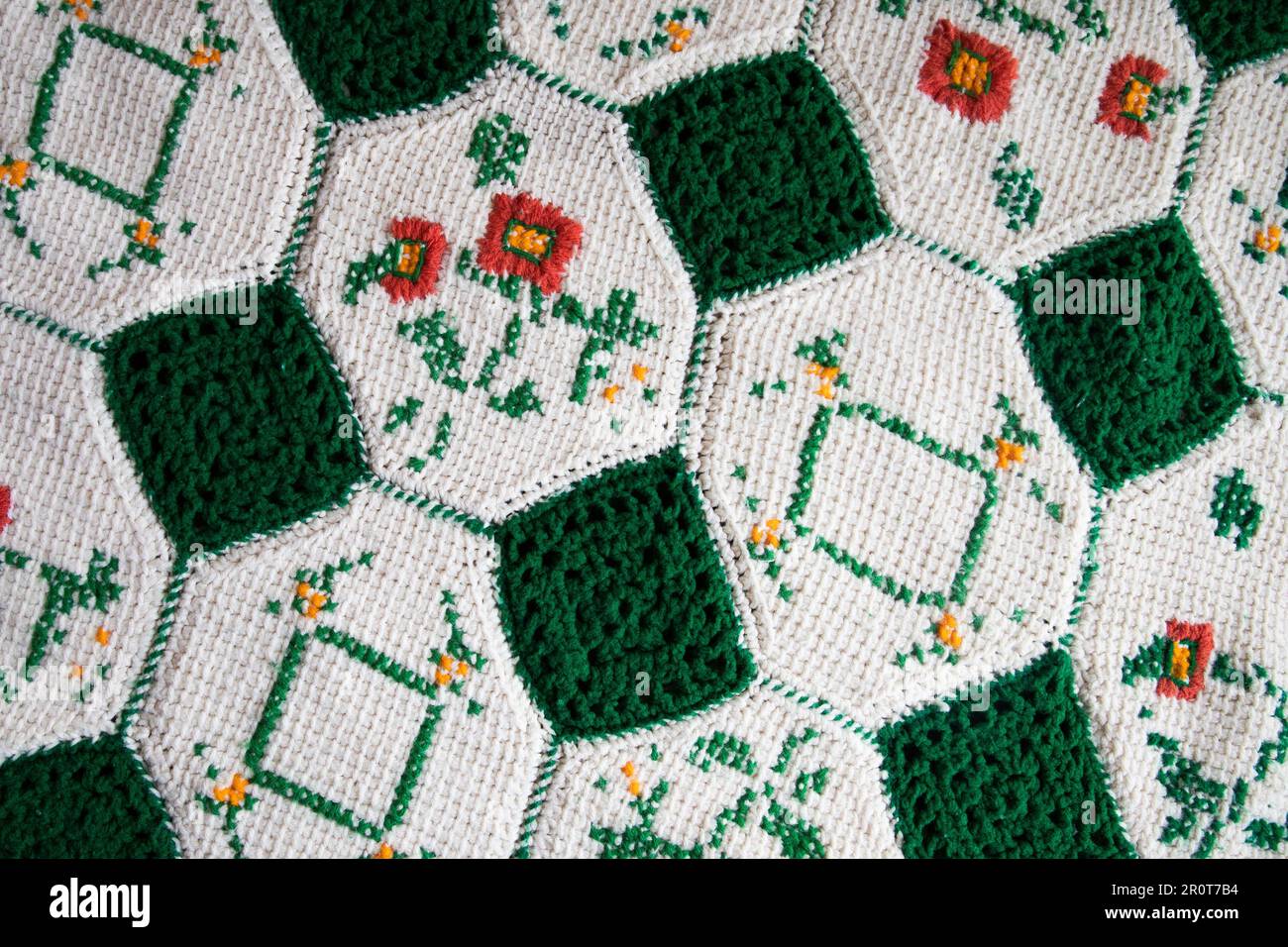 close-up of grandma's crocheted or knitted green and white patch ...