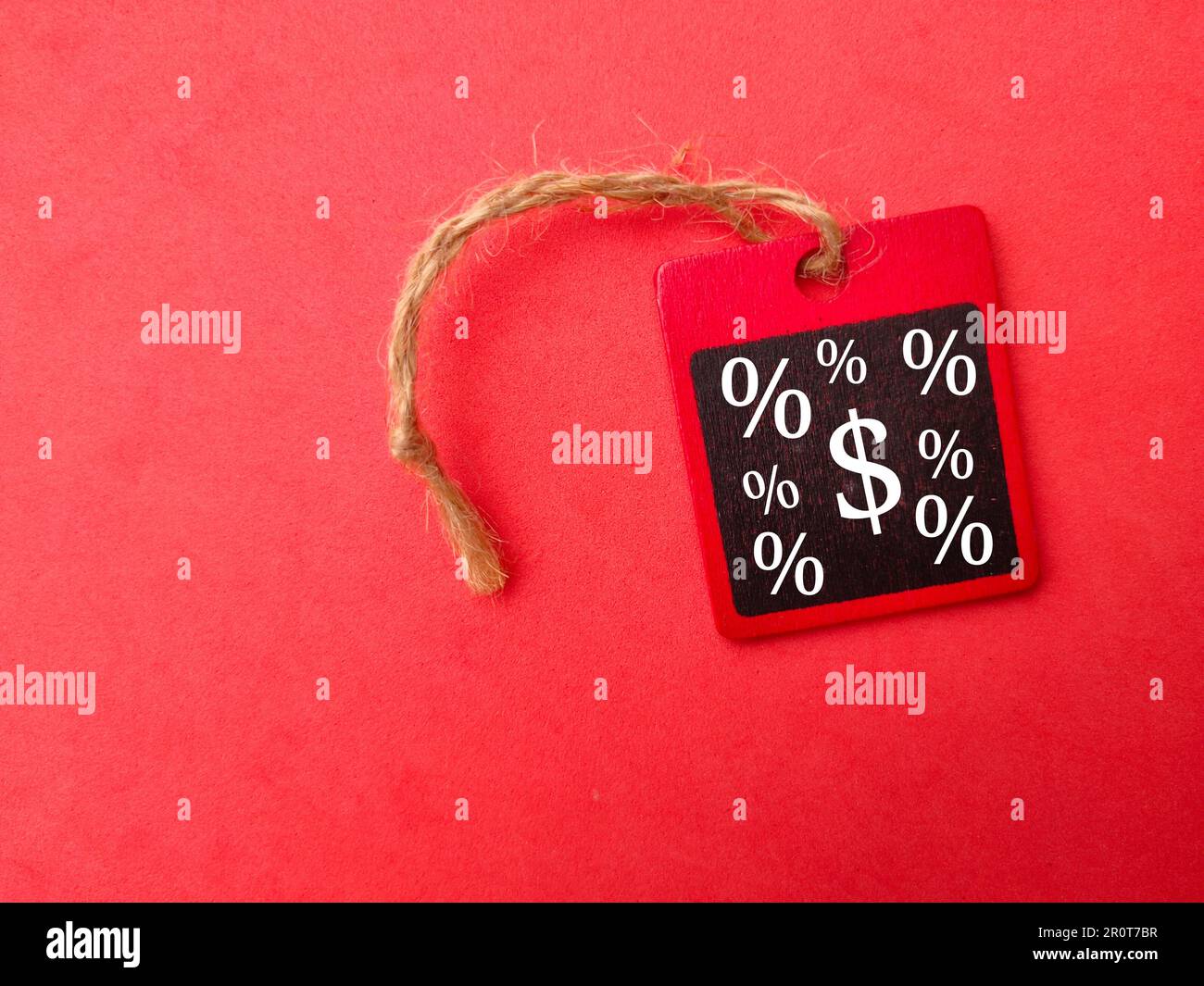 Top view colored wooden board with percentage and money icon on red ...