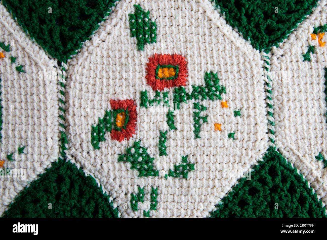 close-up of grandma's crocheted or knitted green and white patch ...