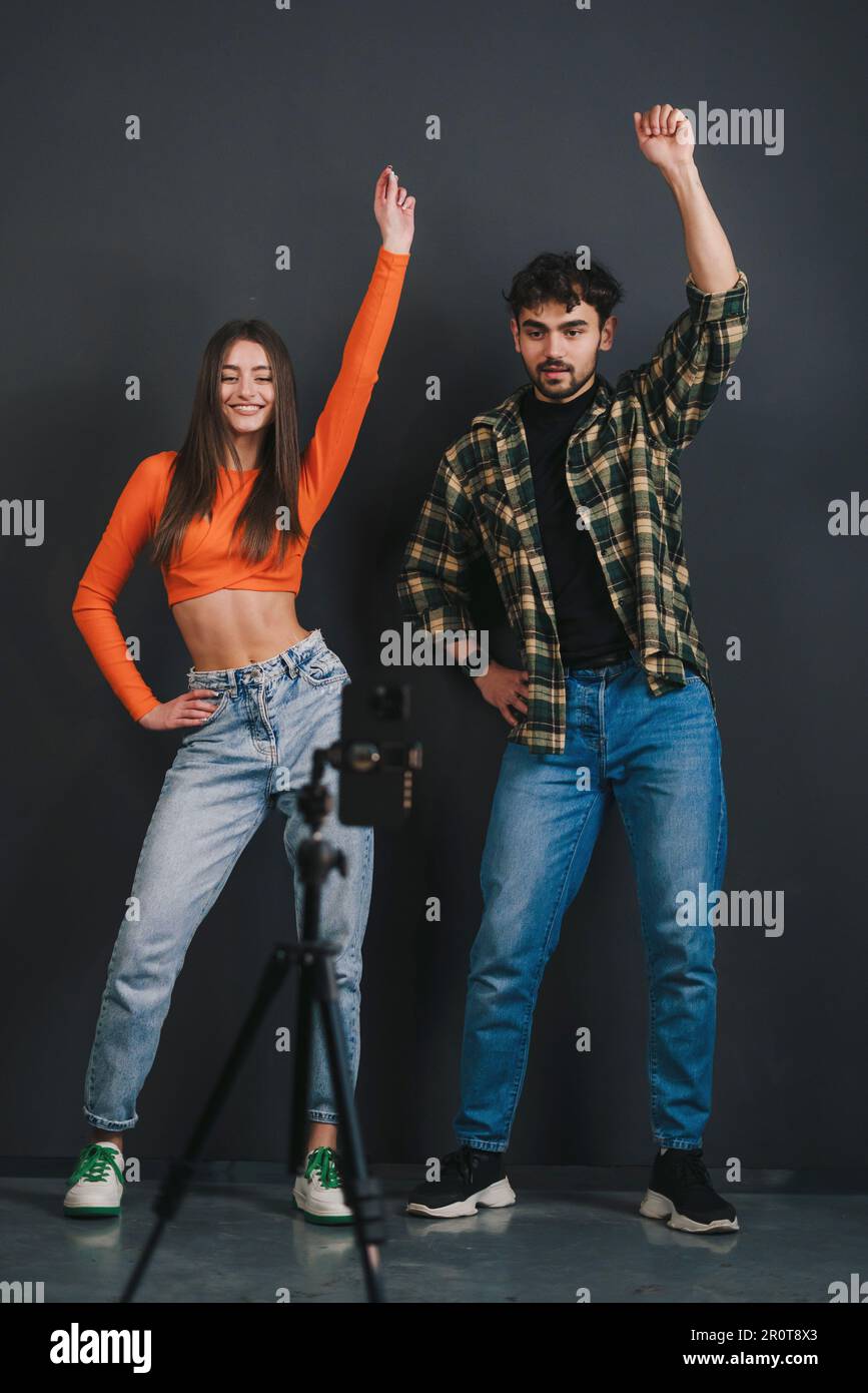 Stylish Caucasian couple in comfy clothes dancing and enjoying life ...
