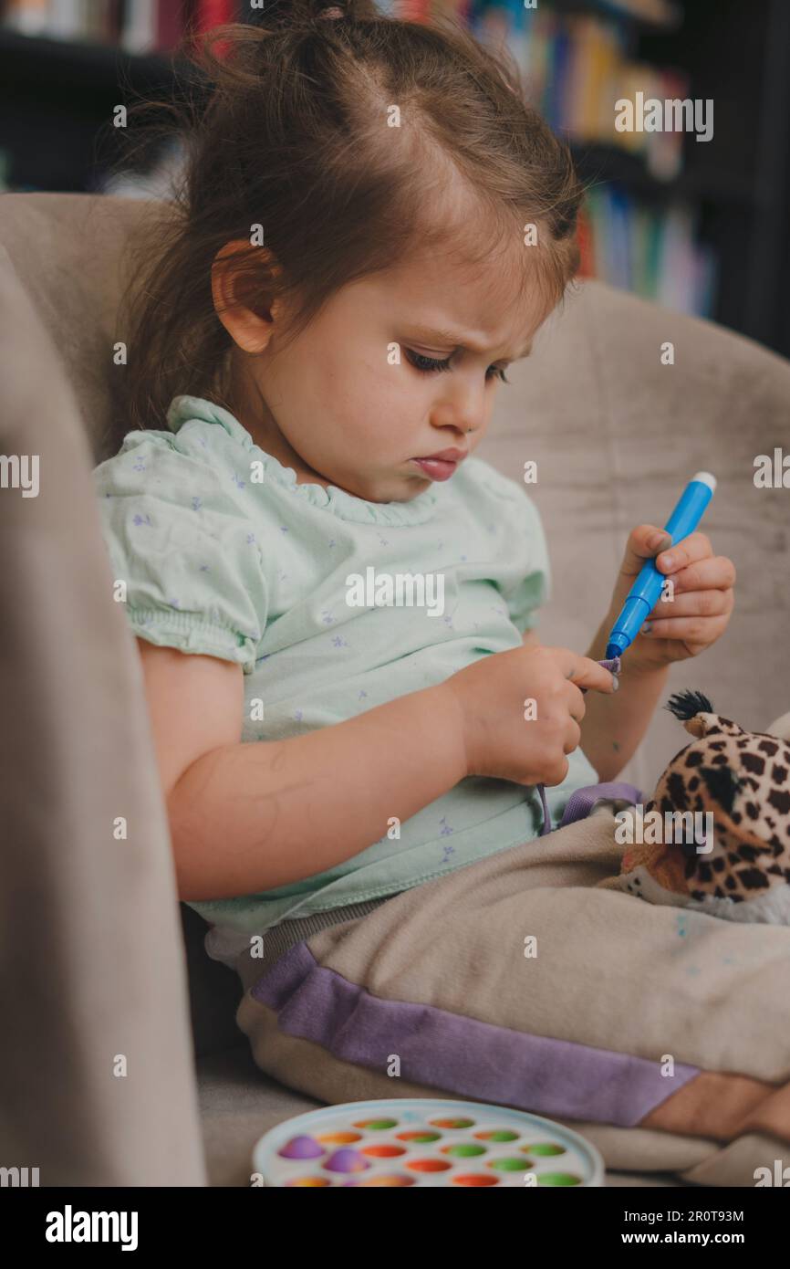 Cute little baby girl drawing with markers in coloring book, art ...