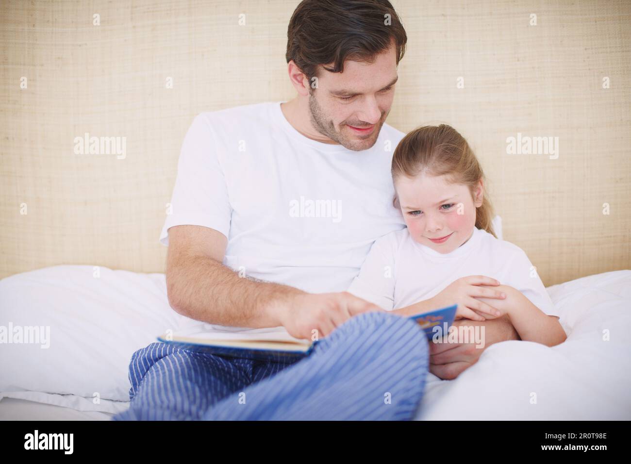 Her favourite picture book. A devoted father reading his young daughter ...