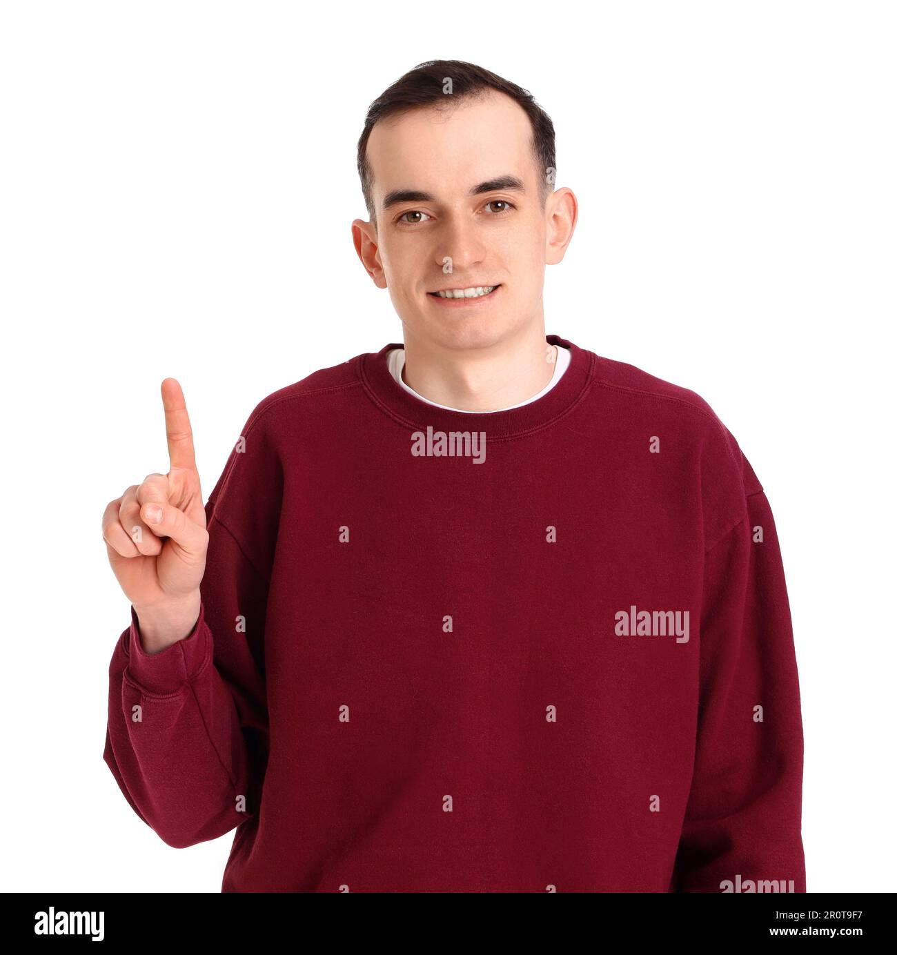 Young man showing one finger on white background Stock Photo - Alamy