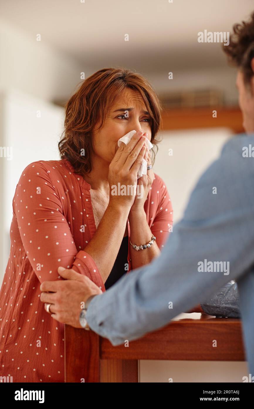 This cant be happening. a woman being comforted by her husband as she ...