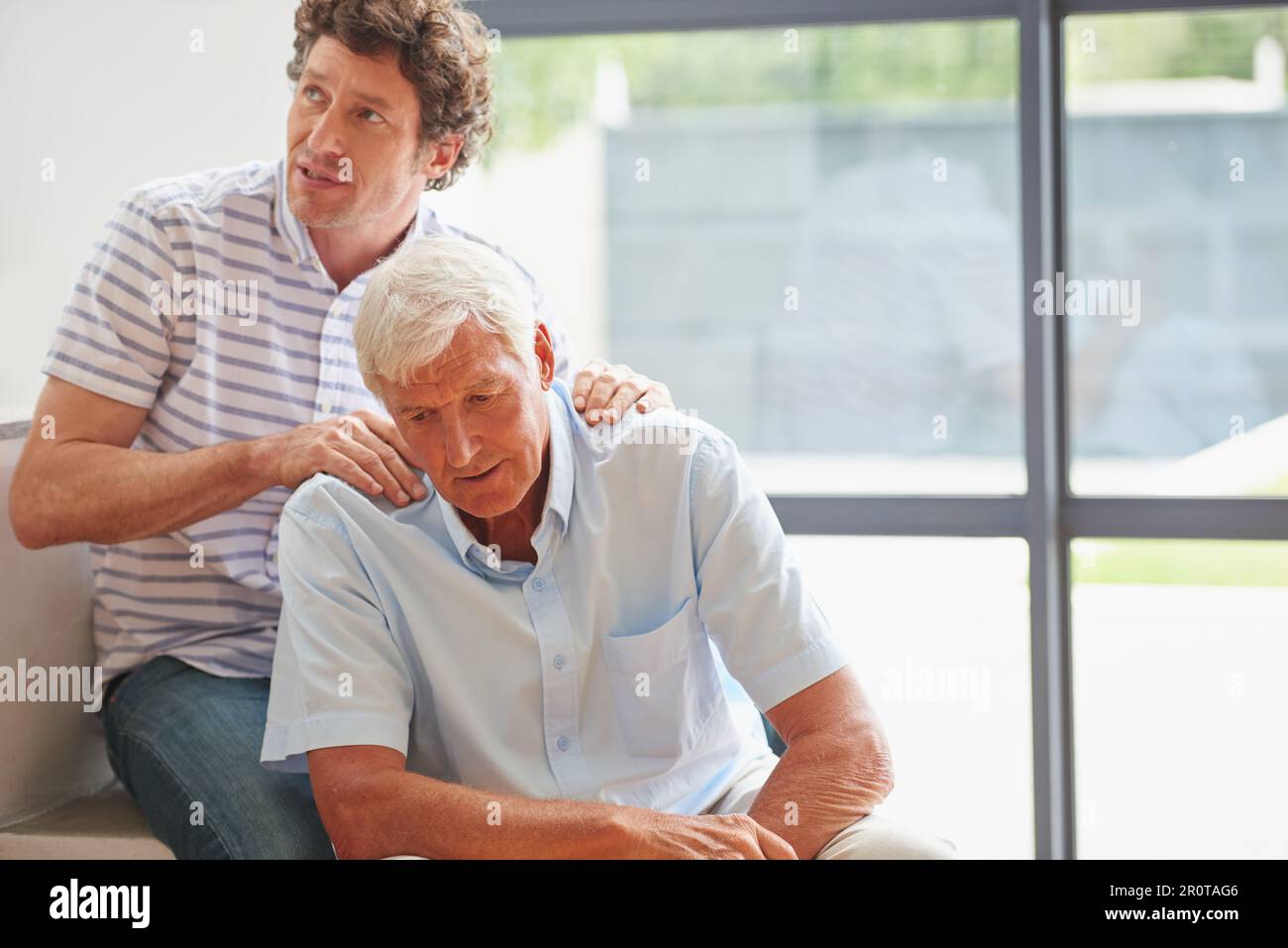 Aging is not for sissies. a man massaging his fathers neck Stock Photo ...