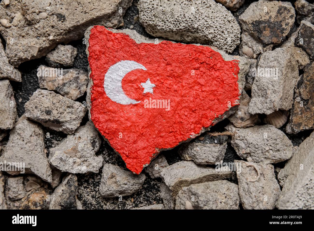 Stone debris with painted Turkish flag on dark background. Turkey ...
