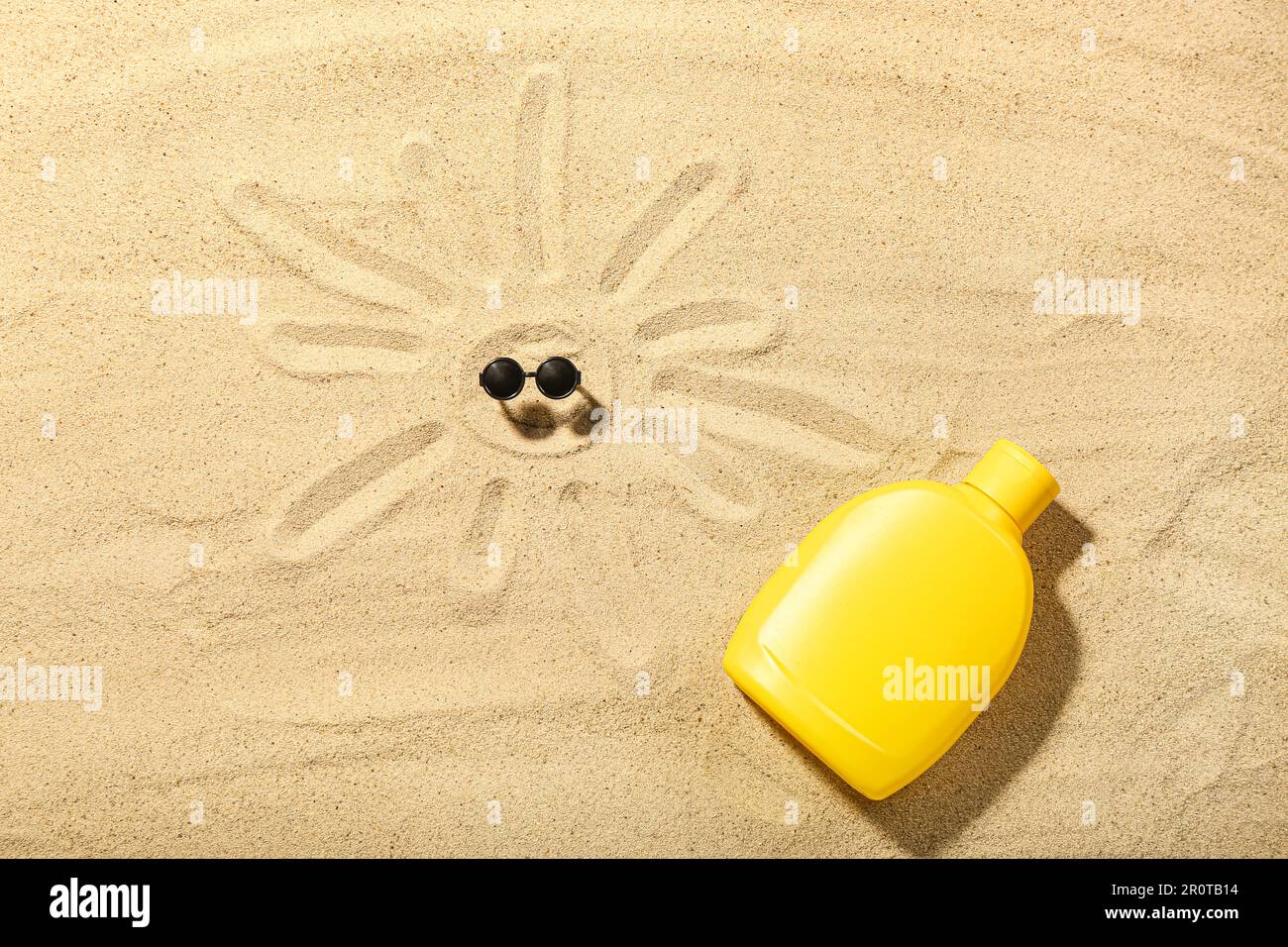 Creative composition with sunscreen cream and miniature sunglasses on ...