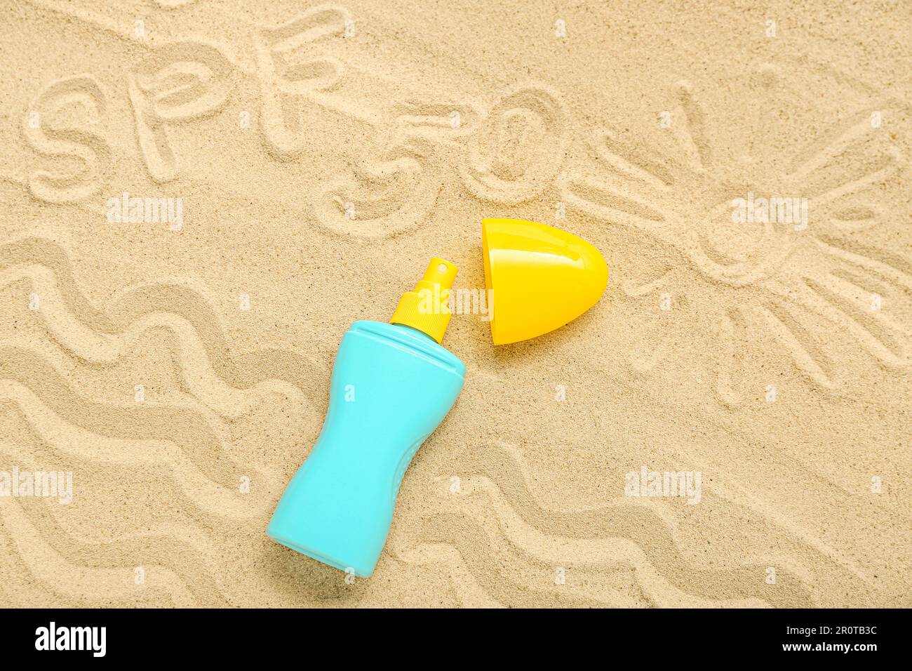 Creative composition with sunscreen cream and drawings on sand Stock ...