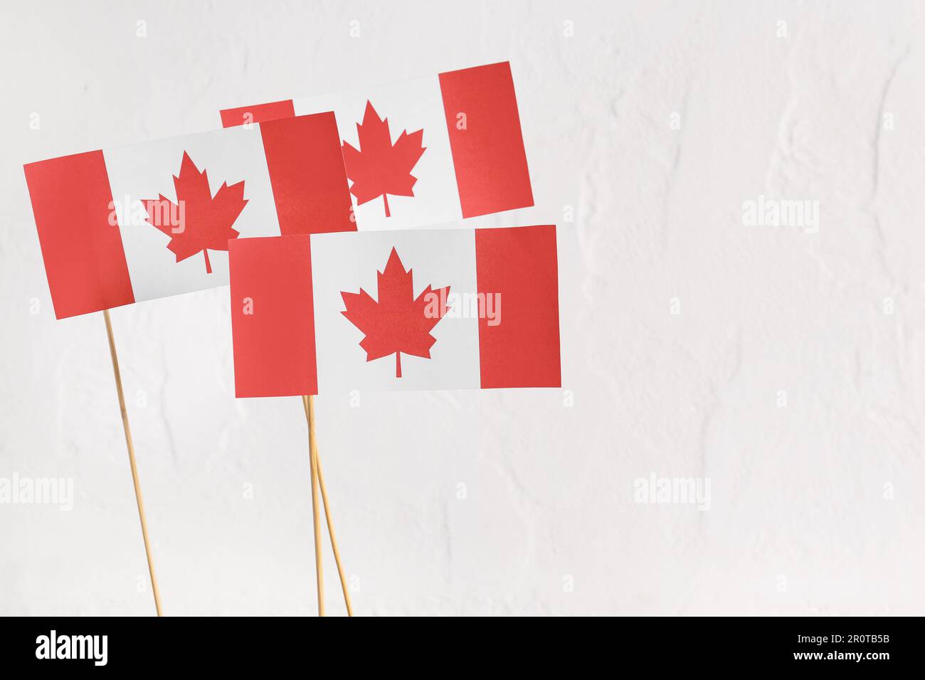 Paper flags of Canada on white background Stock Photo - Alamy